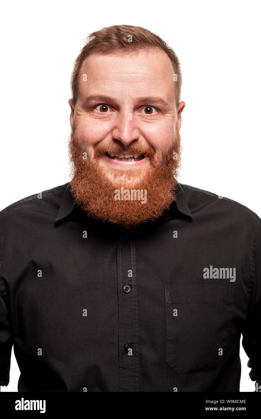 Portrait of a young, chubby, redheaded man in a black shirt making ...