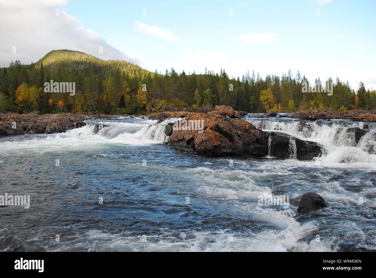Stunning blue River with rocks and forest Stock Photo - Alamy