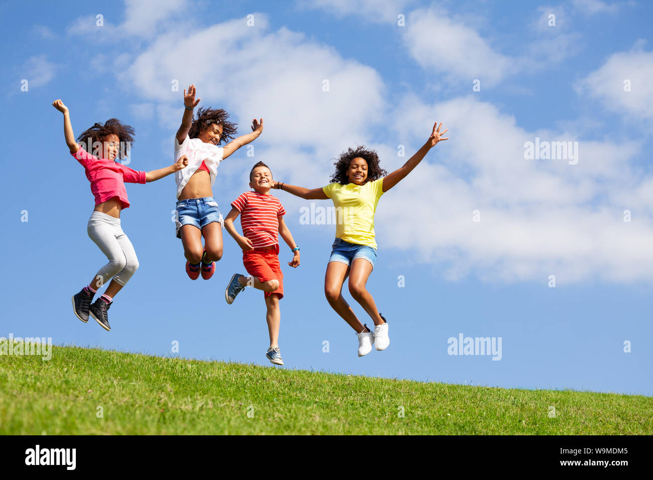 Four children playing outside hi-res stock photography and images - Alamy