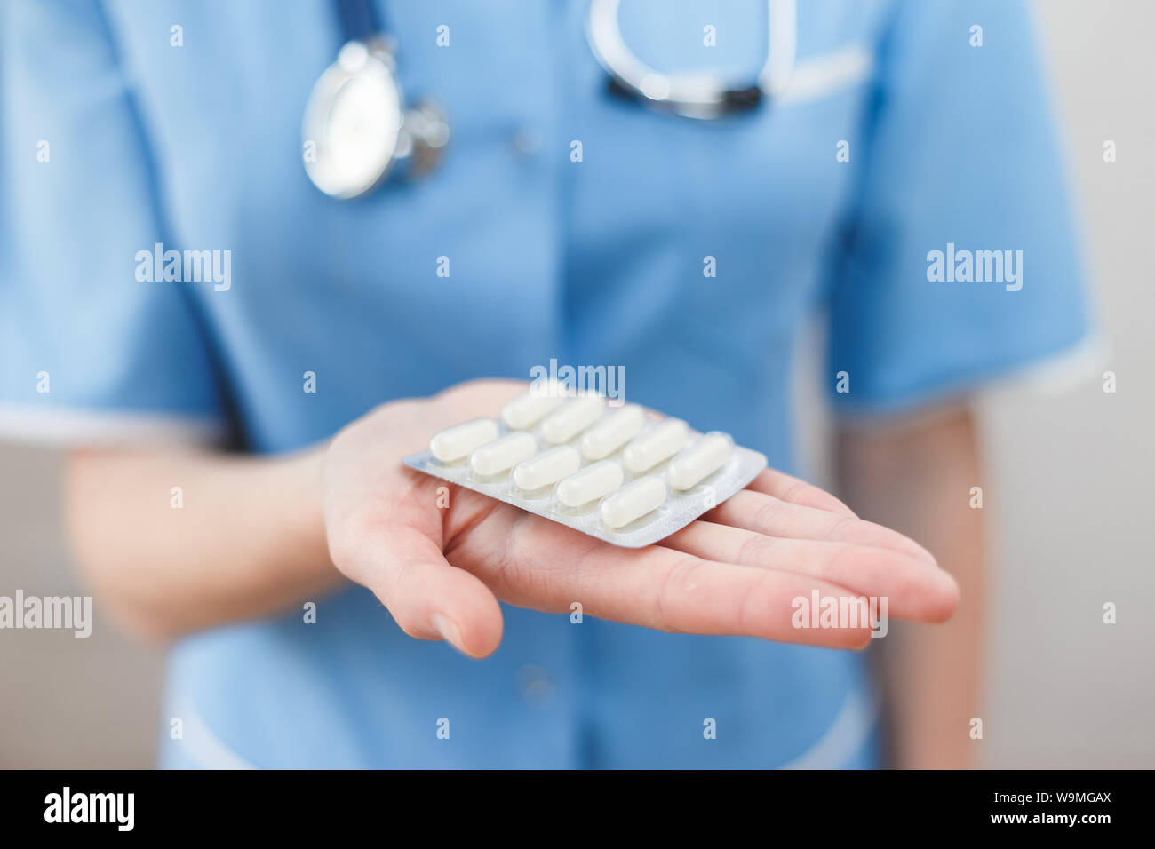 Female doctor holds pills hi-res stock photography and images - Alamy