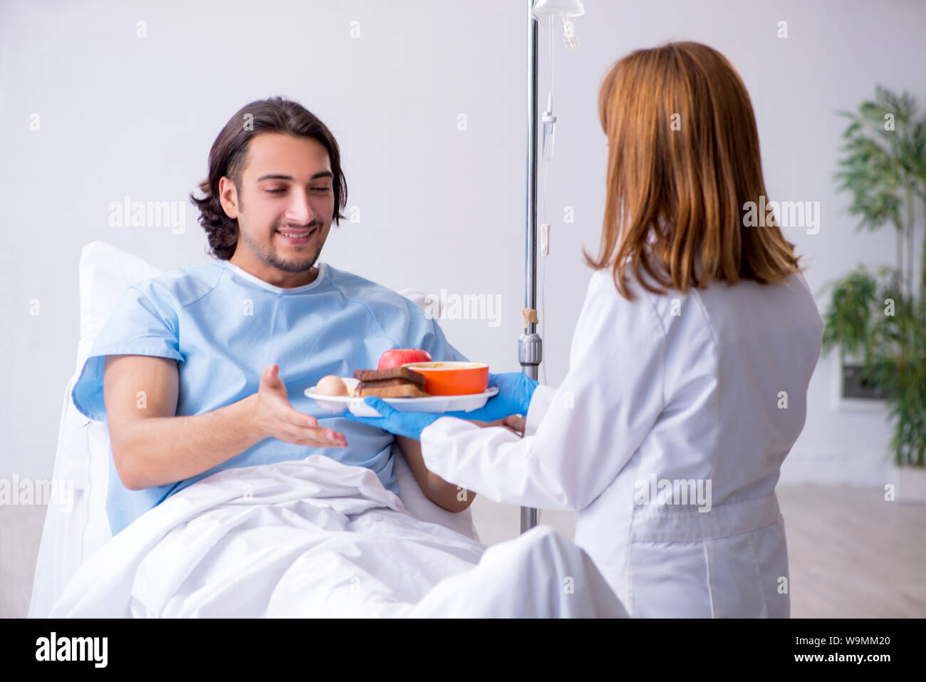 The male patient eating food in the hospital Stock Photo - Alamy