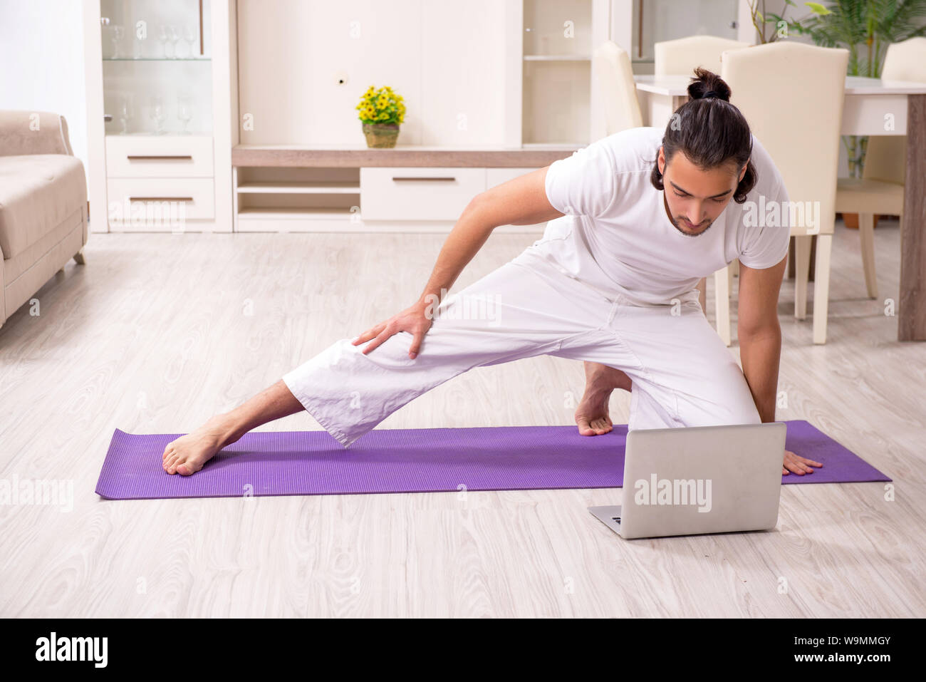 The young man doing physical exercises at home Stock Photo - Alamy