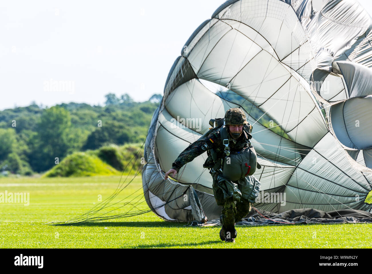 Soldier running across the dropzone at 2019 Leapfest, an international ...