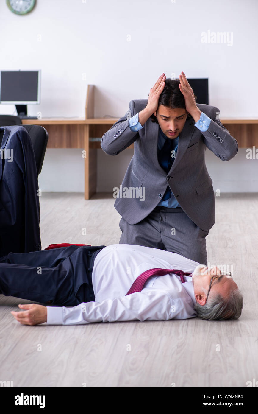 The male employee suffering from heart attack in the office Stock Photo ...