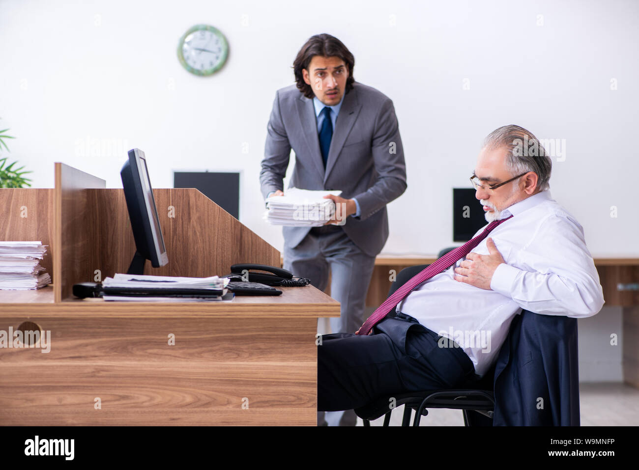 The male employee suffering from heart attack in the office Stock Photo ...