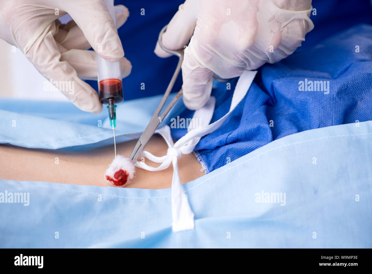 The female patient getting an injection in the clinic Stock Photo - Alamy