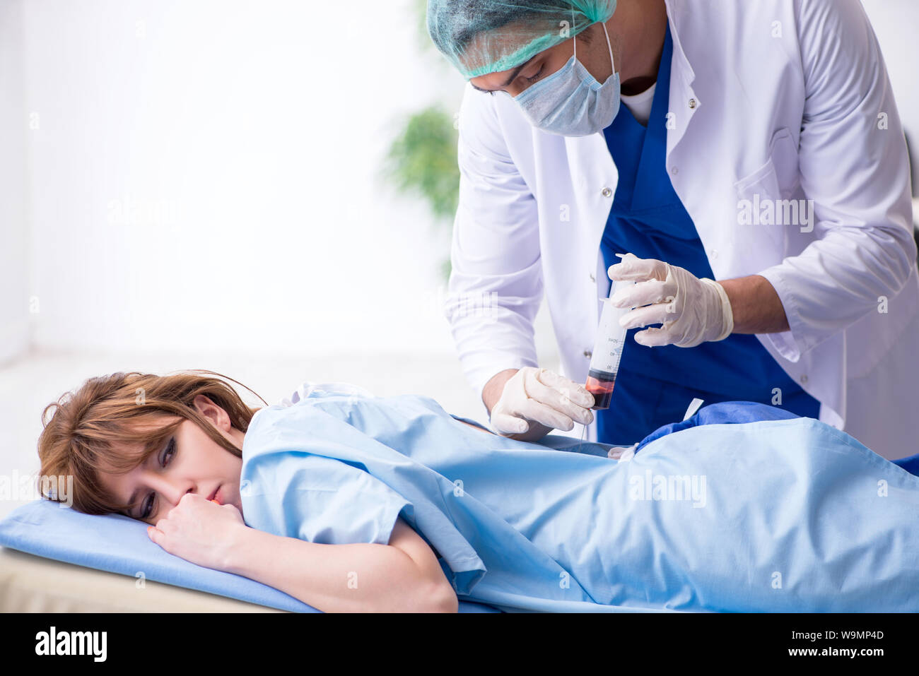 The female patient getting an injection in the clinic Stock Photo - Alamy