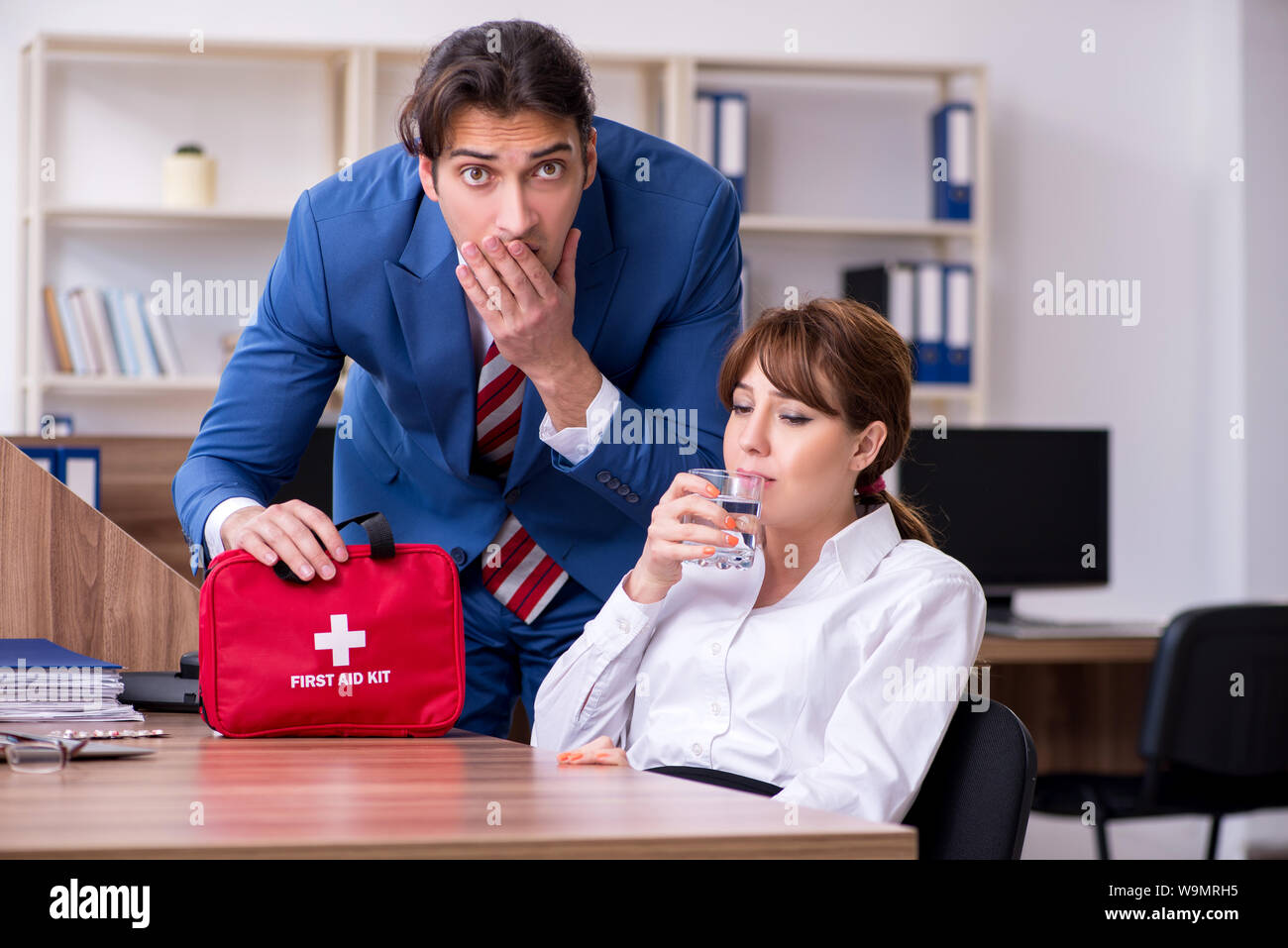 Employee receiving first aid in office Stock Photo - Alamy