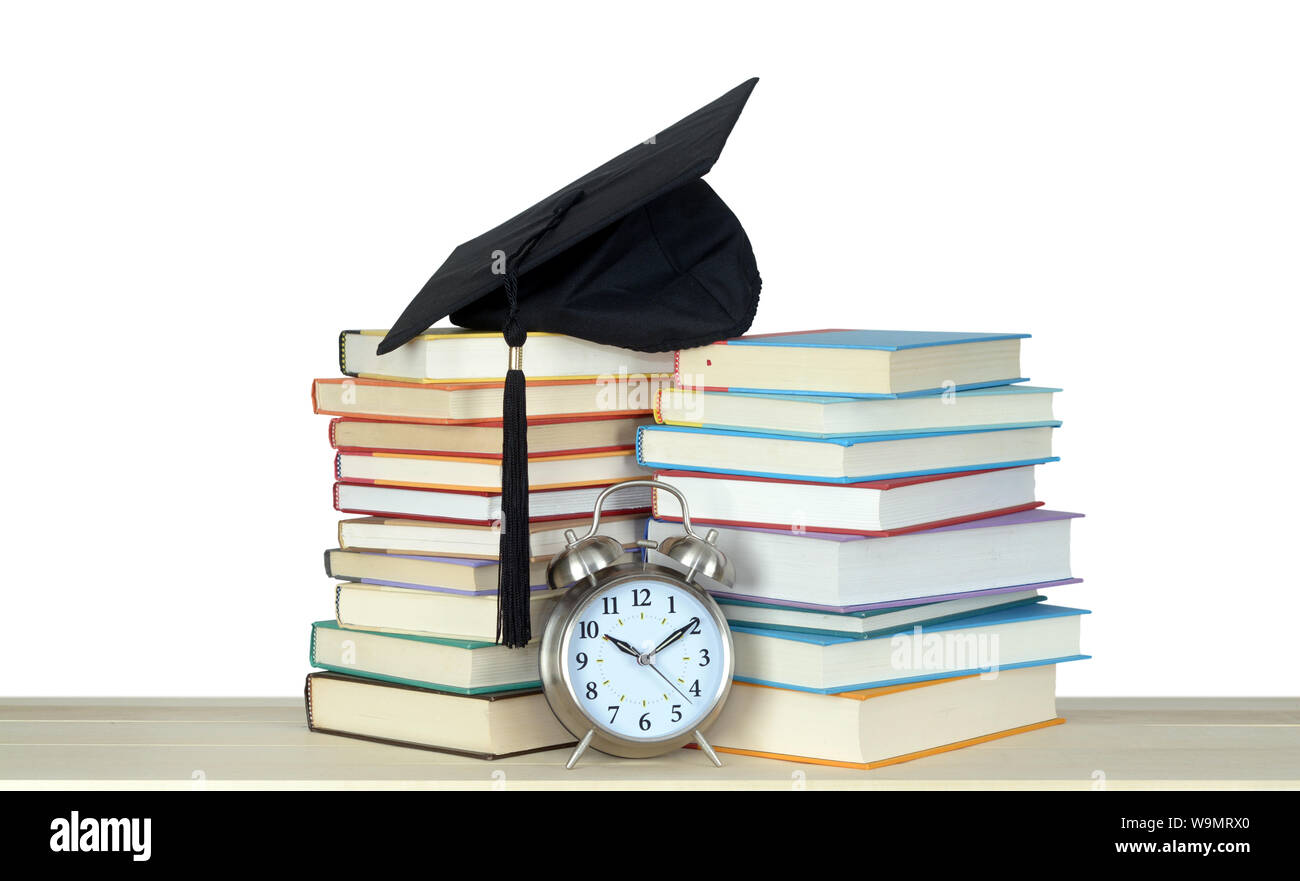 book and graduation cap with clock over on white Stock Photo - Alamy