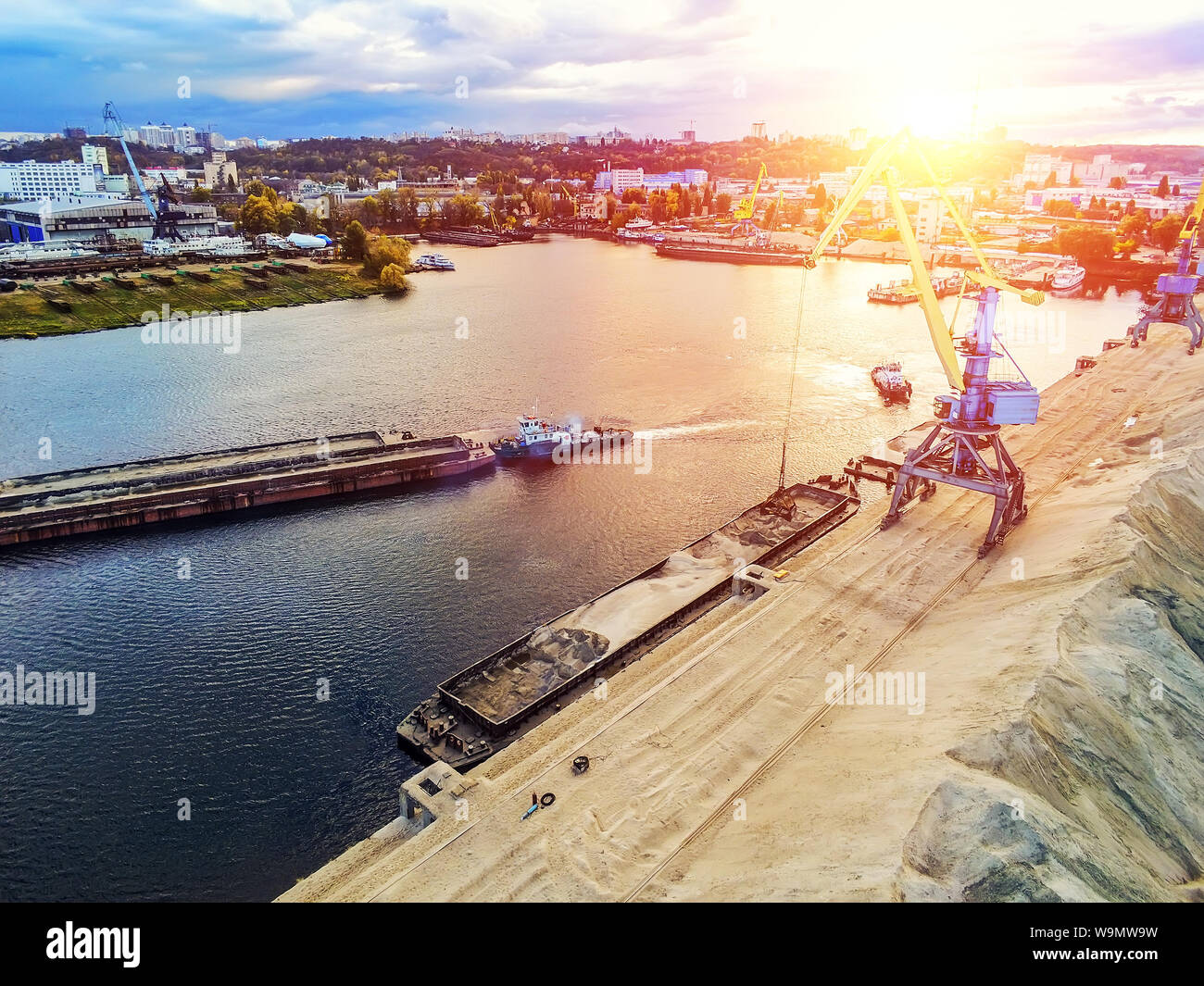 Aerial view of heavy crane loading bulk goods at Dnieper river cargo ...