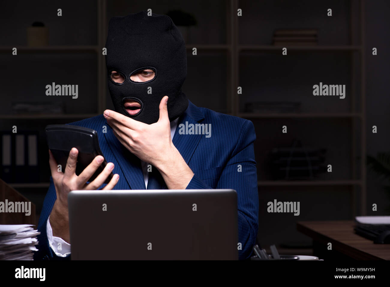 The male employee stealing information in the office night time Stock ...