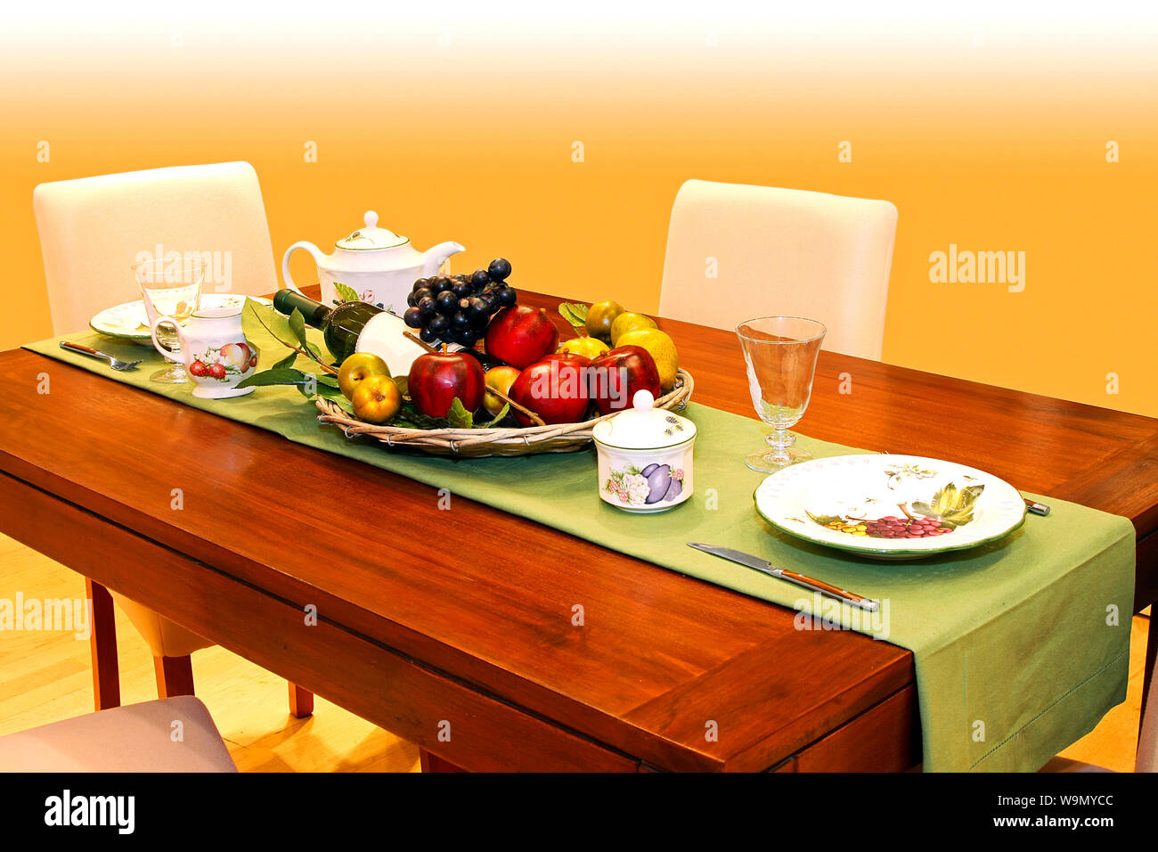 Kitchen table setup for breakfast with fruits Stock Photo - Alamy