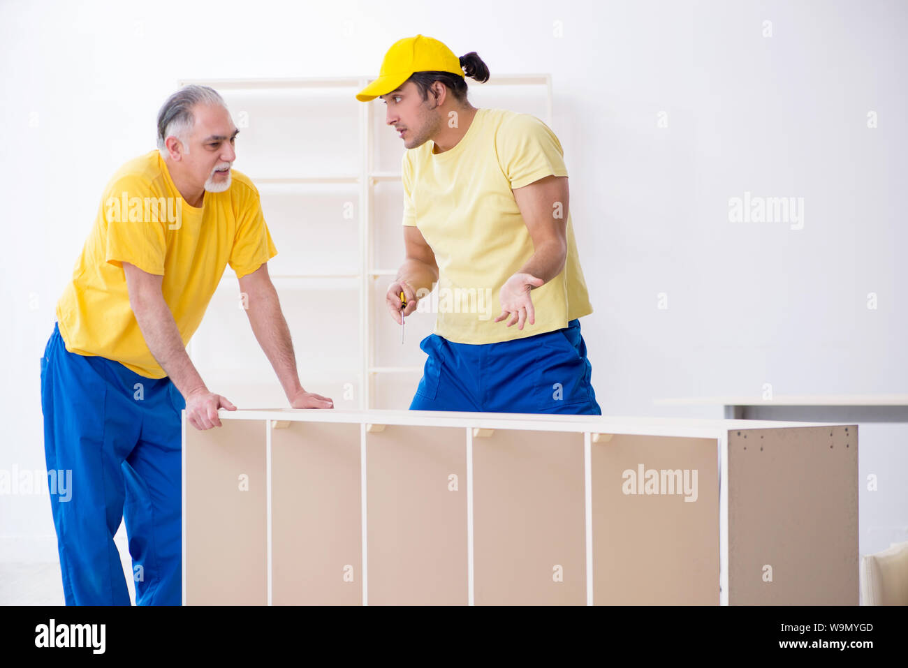 Carpenters discussing in construction hi-res stock photography and ...