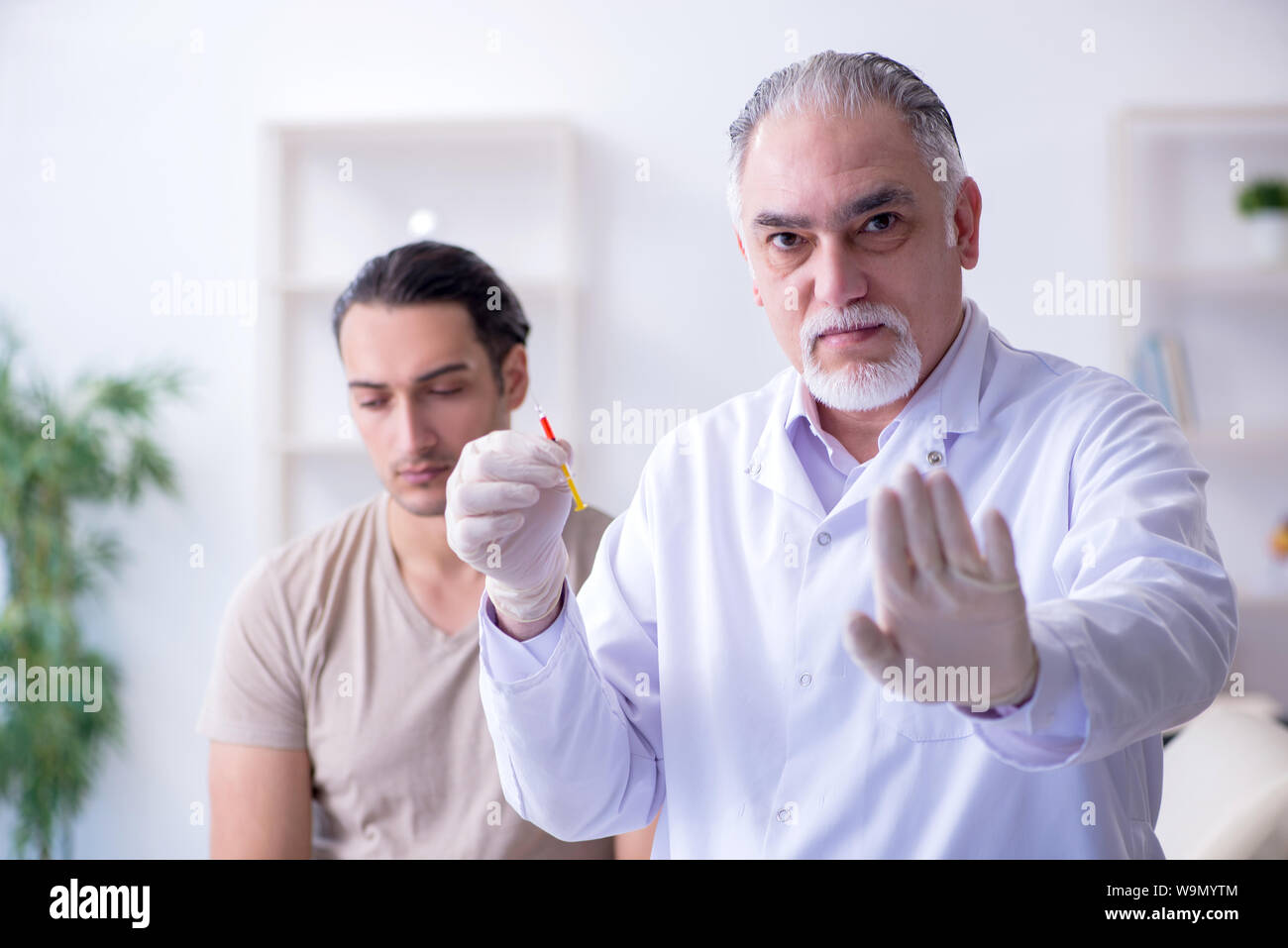 The male patient visitng doctor for shot inoculation Stock Photo - Alamy