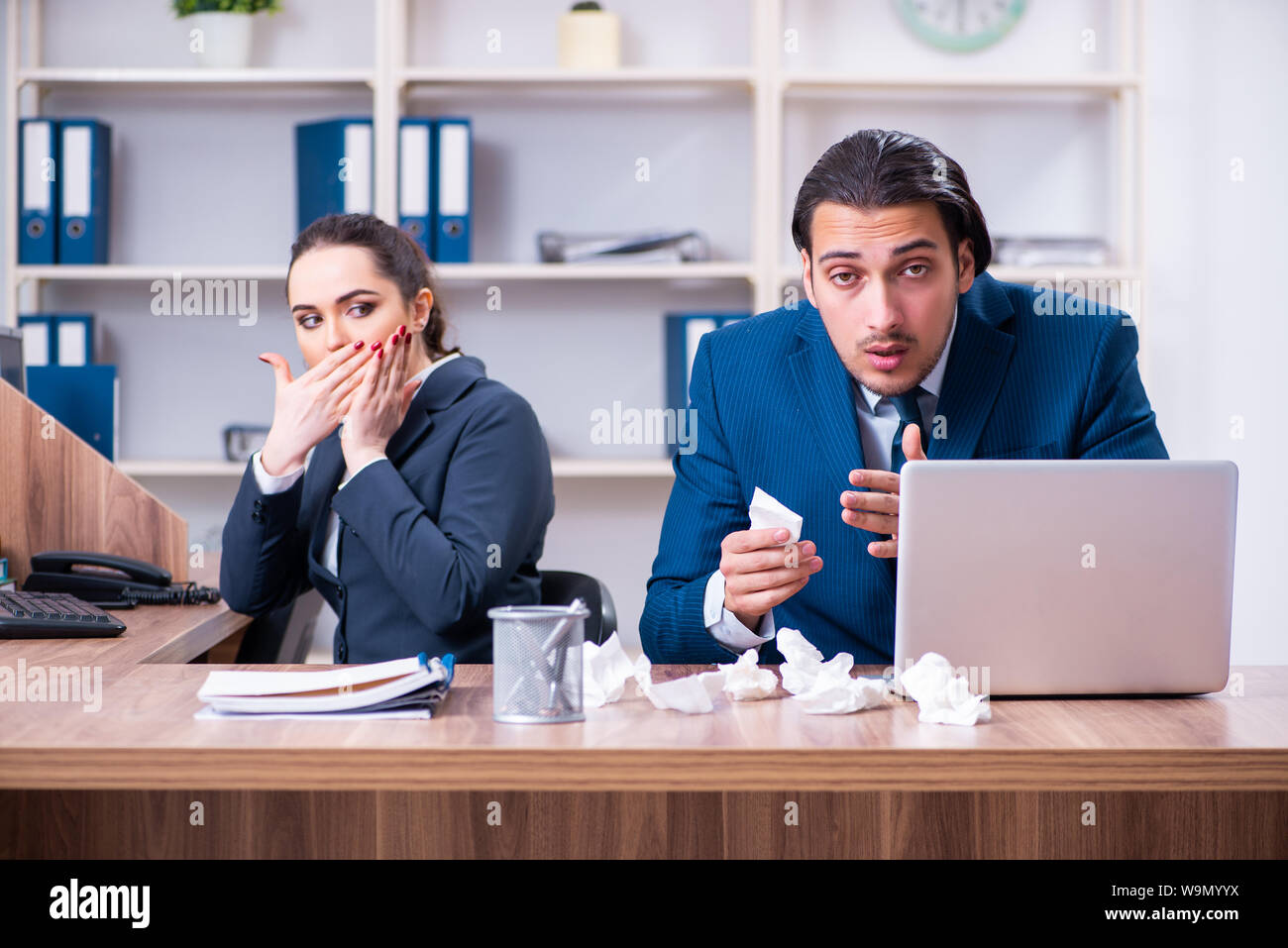 The two employees suffering at workplace Stock Photo - Alamy