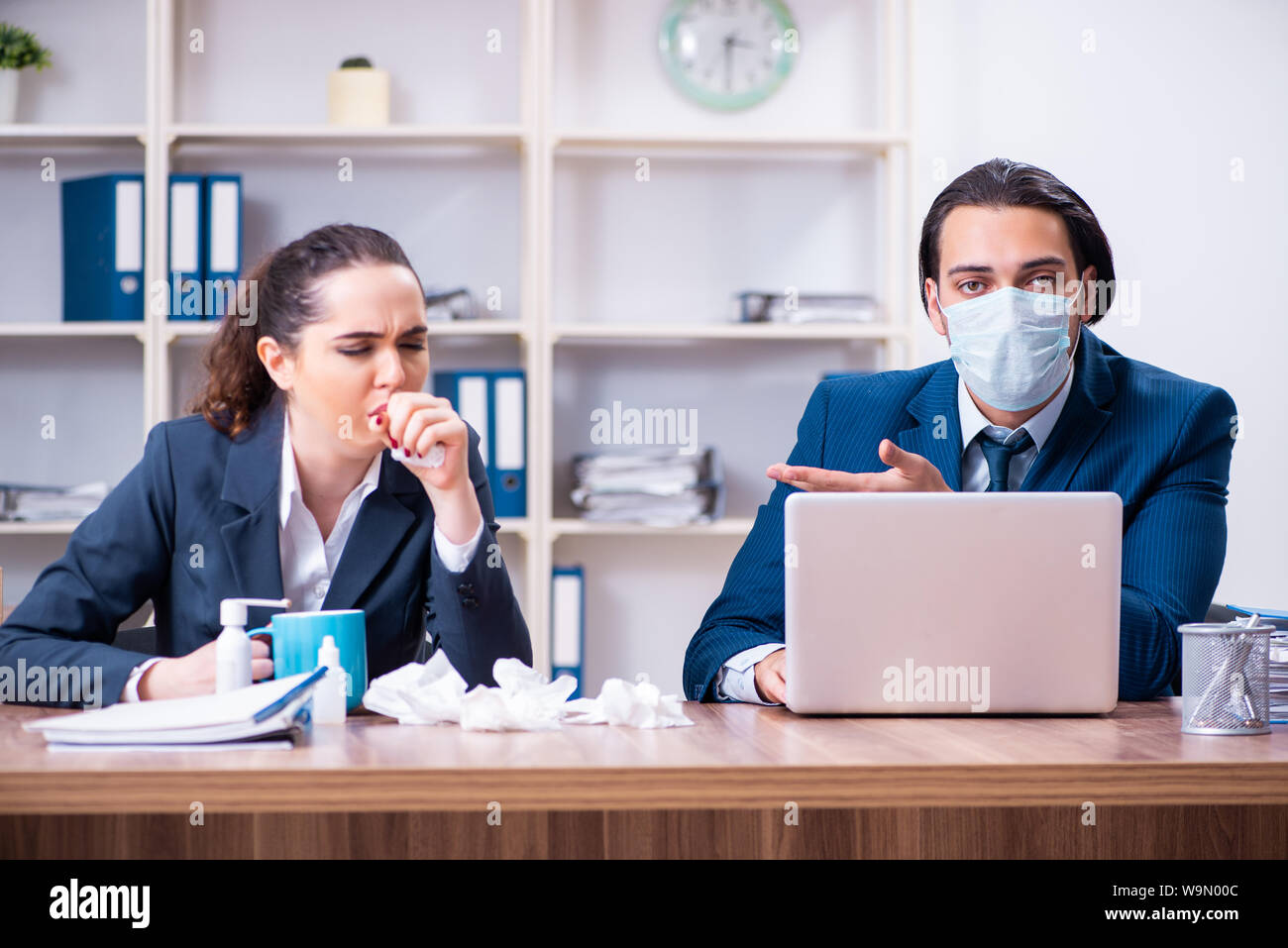 The two employees suffering at workplace Stock Photo - Alamy