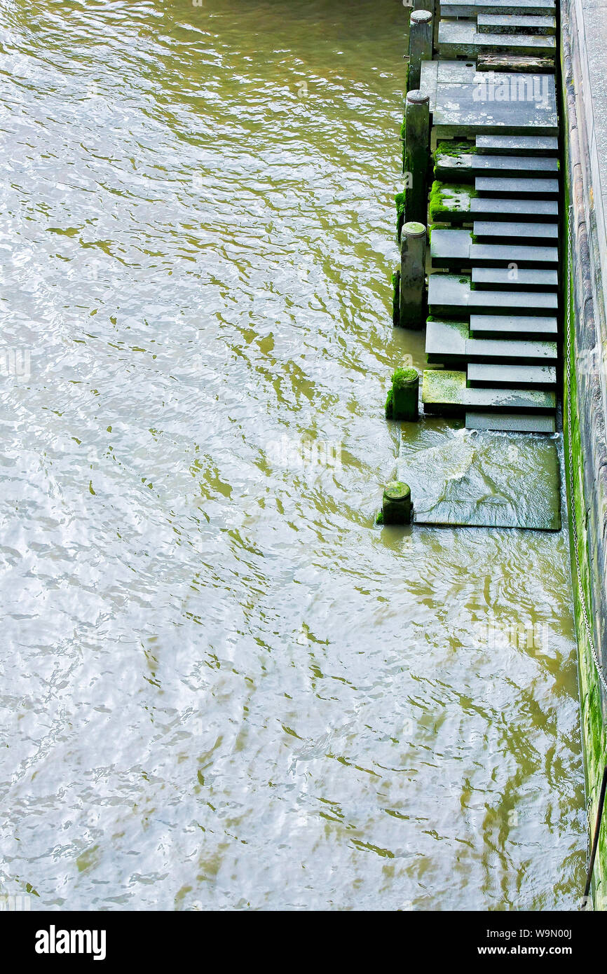 Stairs descending in river water at dock Stock Photo - Alamy