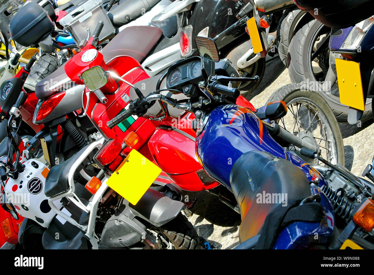 Overcrowded parking space for motorbikes and scooters Stock Photo - Alamy