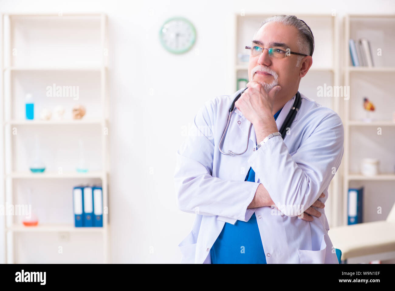 Focused senior old doctor working hi-res stock photography and images ...