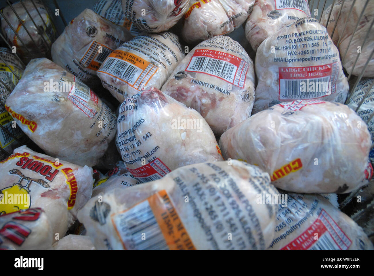 Packets of frozen chicken in supermarket freezer, Lilongwe, Malawi ...