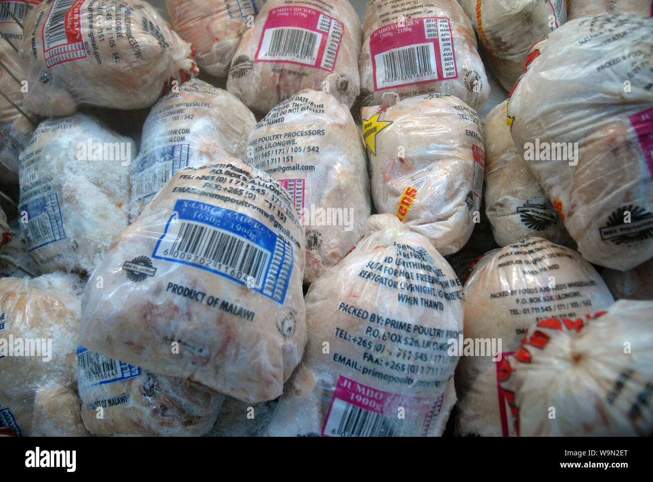 Packets of frozen chicken in supermarket freezer, Lilongwe, Malawi ...