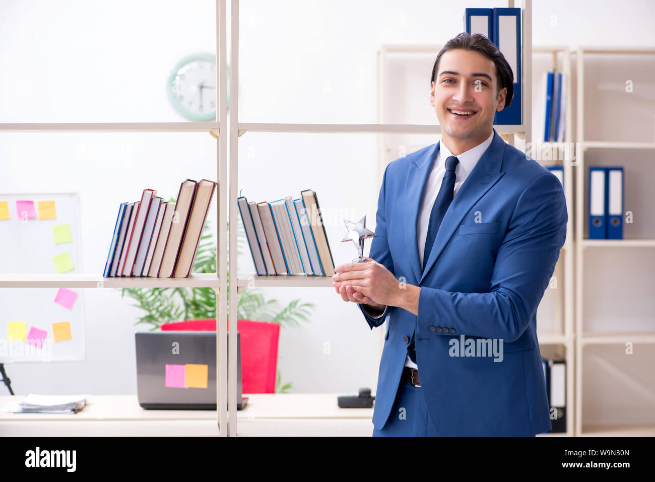 The young handsome employee in the office Stock Photo - Alamy