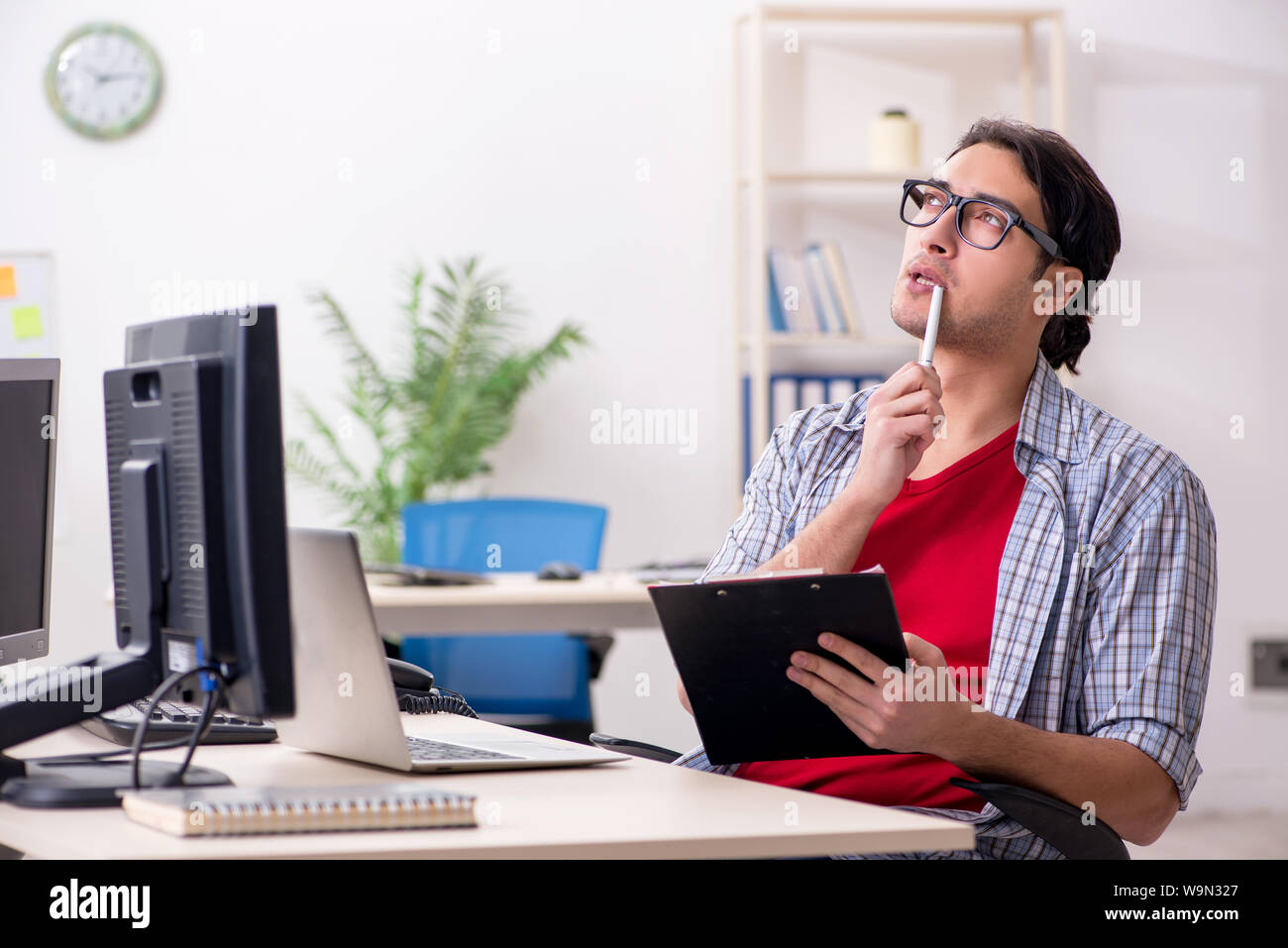 The male it specialist working in the office Stock Photo - Alamy