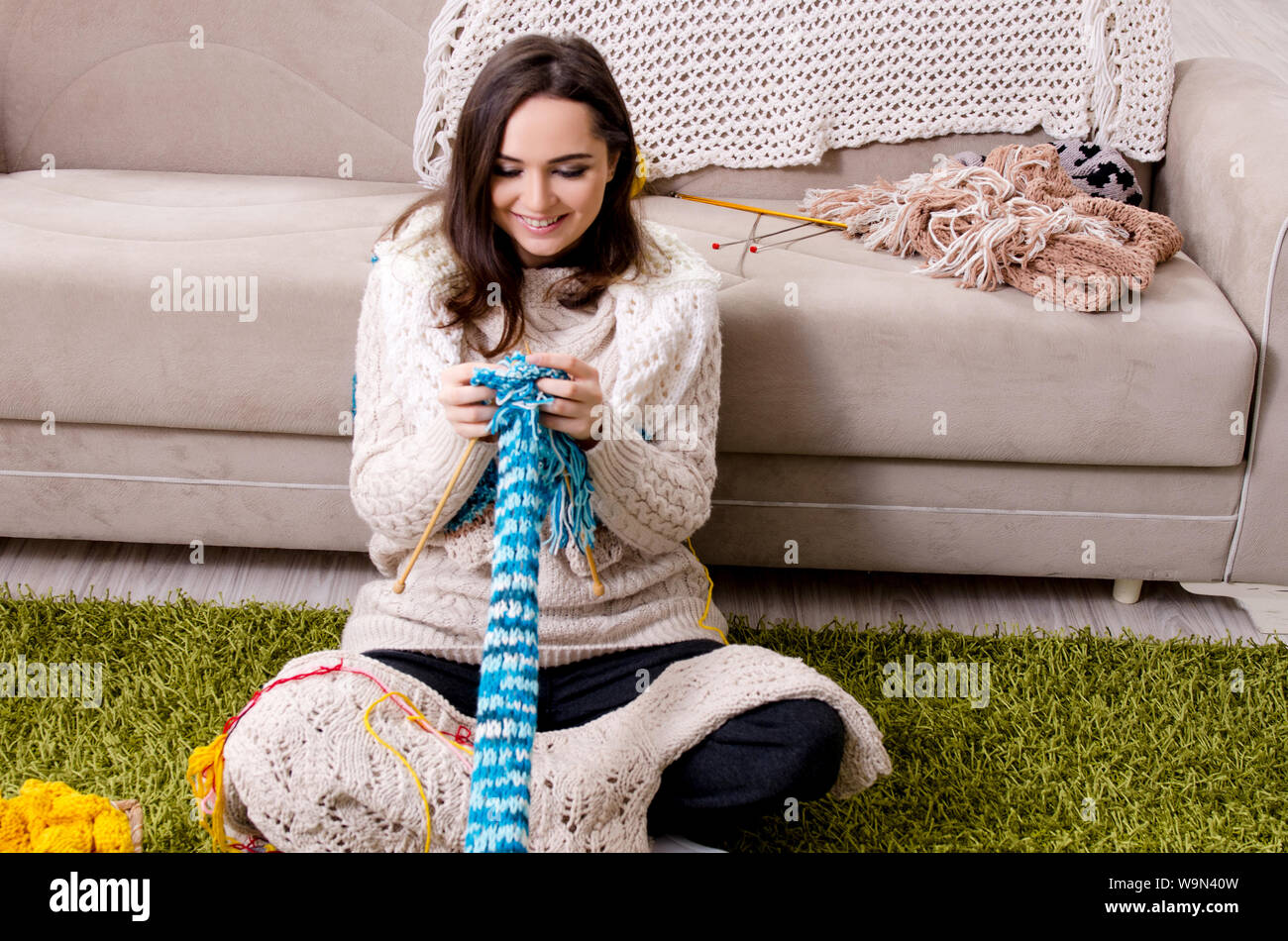 The young beautiful woman knitting at home Stock Photo - Alamy