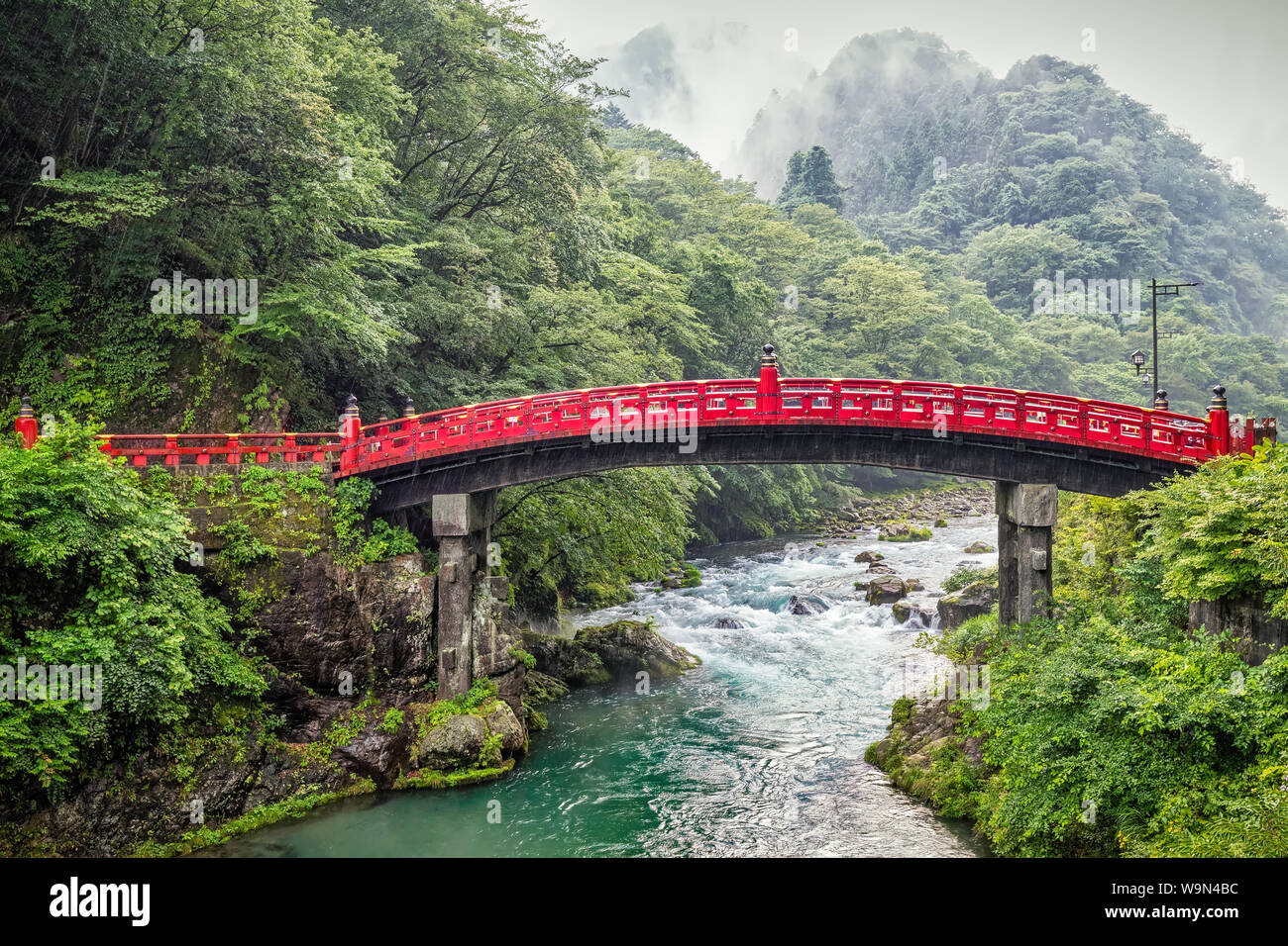 A rain storm at the Shinkyo, or Sacred Bridge, crossing the Daiya River ...