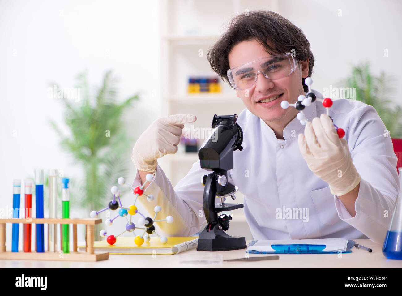 The young male biochemist working in the lab Stock Photo - Alamy