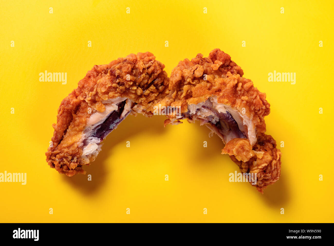 top view fresh deep fried chicken drumstick and wing with a bite on ...