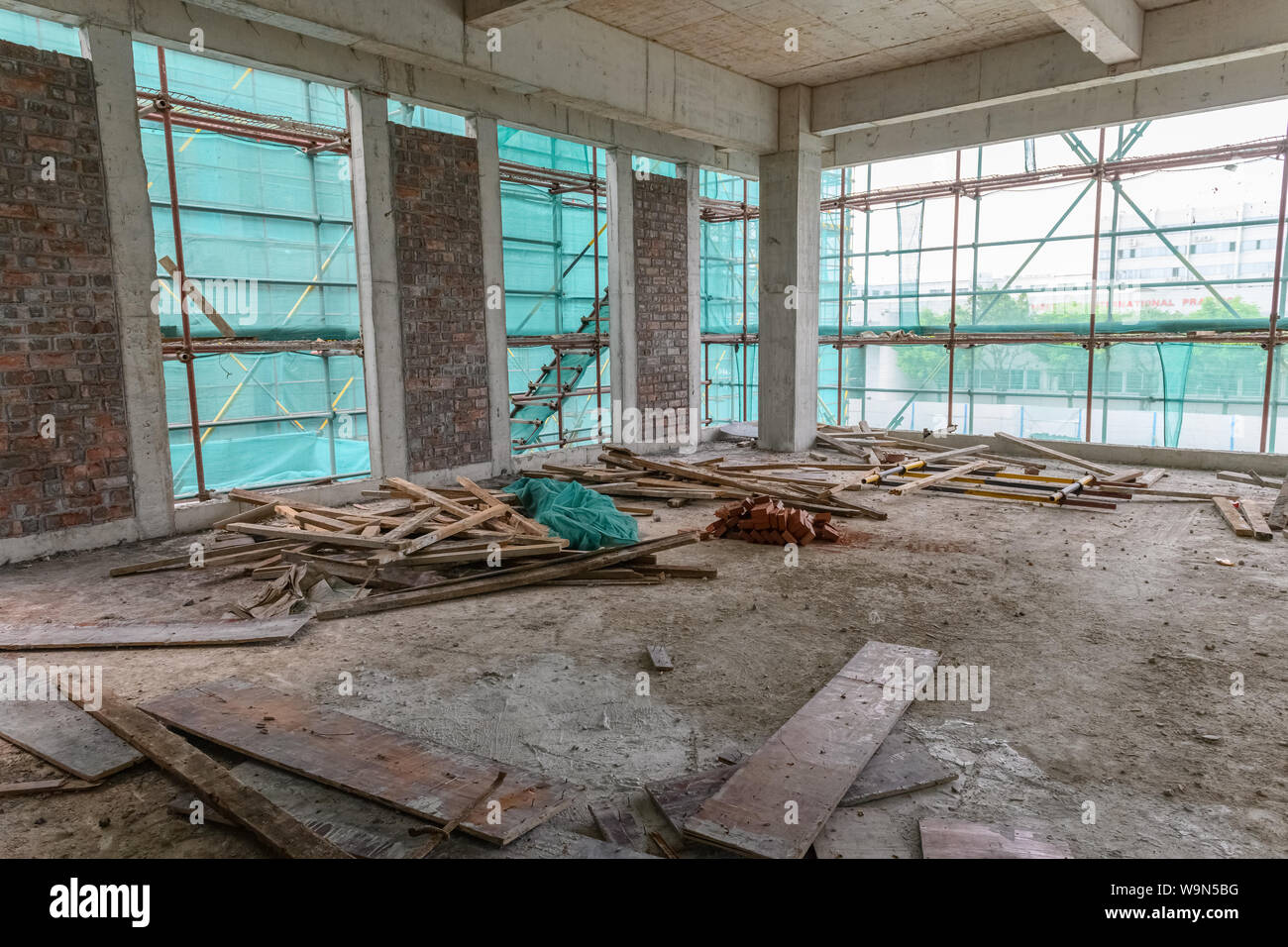 inside of an unfinshed building with protection scaffolding and netting ...