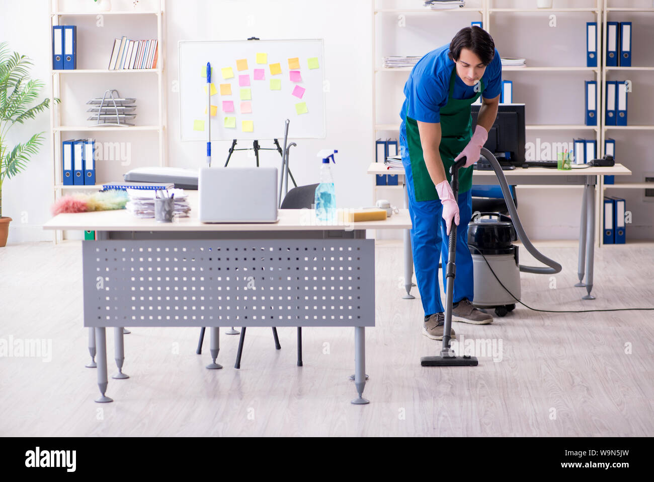 The male handsome professional cleaner working in the office Stock ...