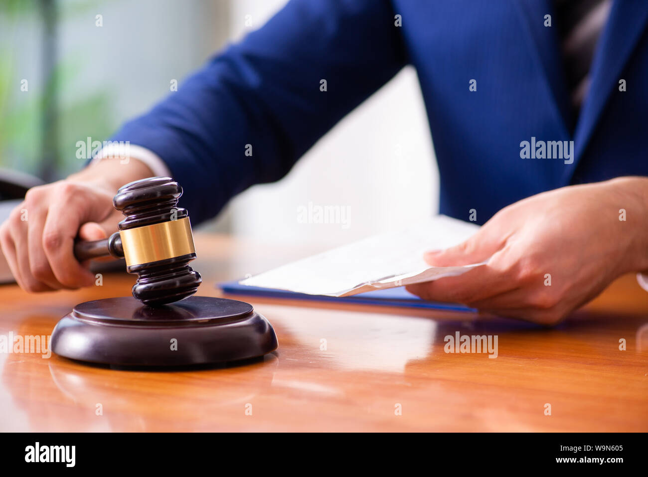 The young male judge sitting in courtroom Stock Photo - Alamy