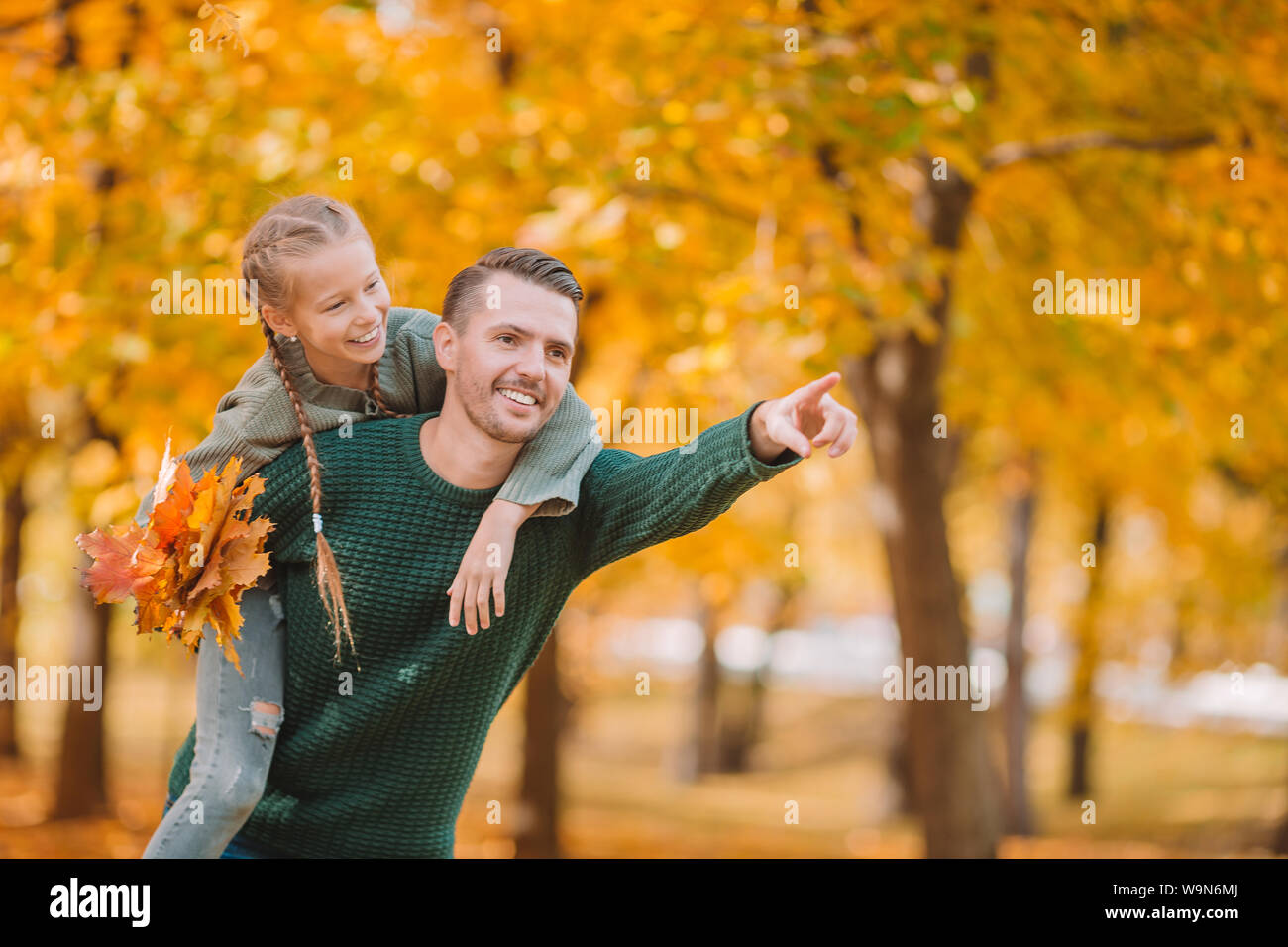 Family of dad and kid on beautiful autumn day in the park Stock Photo ...