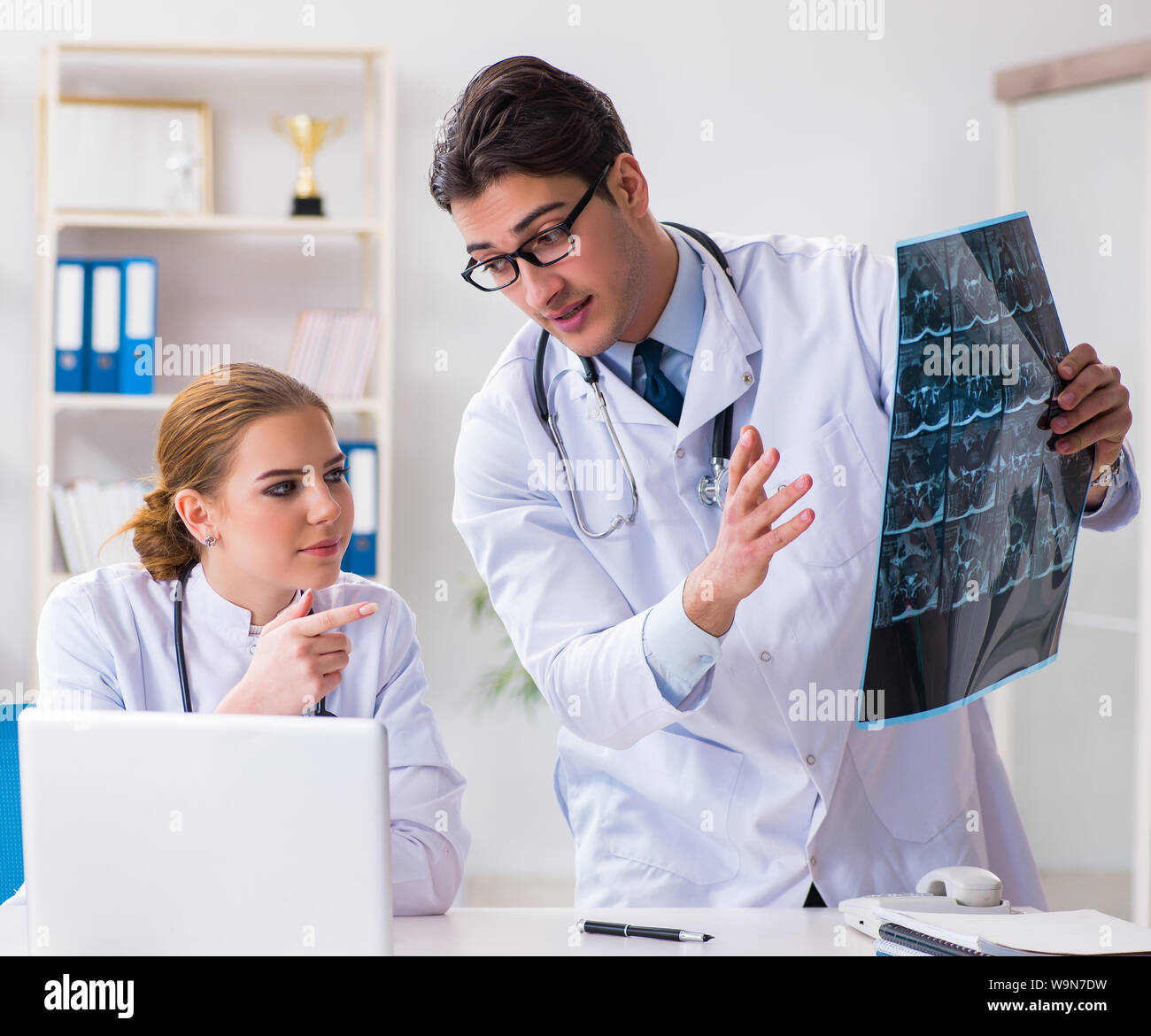 The two doctors examining x-ray images of patient for diagnosis Stock ...