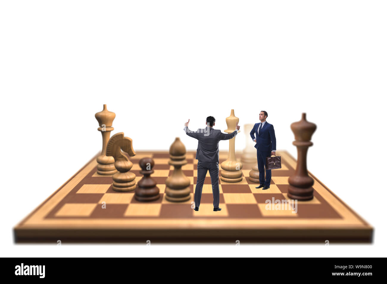 The businessman in large chess board in strategy concept Stock Photo ...