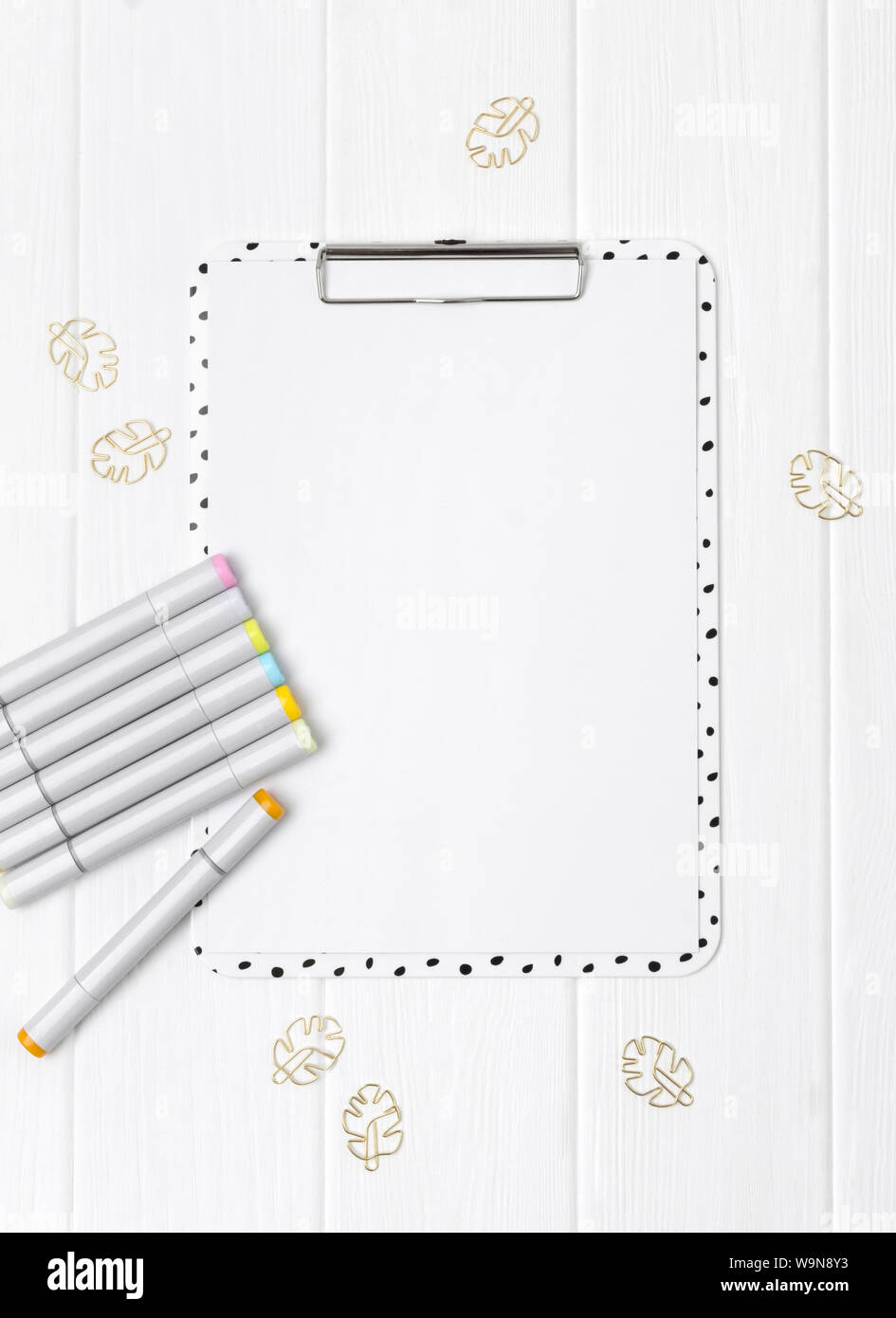 Modern clipboard with blank sheet and markers and clip on a white ...