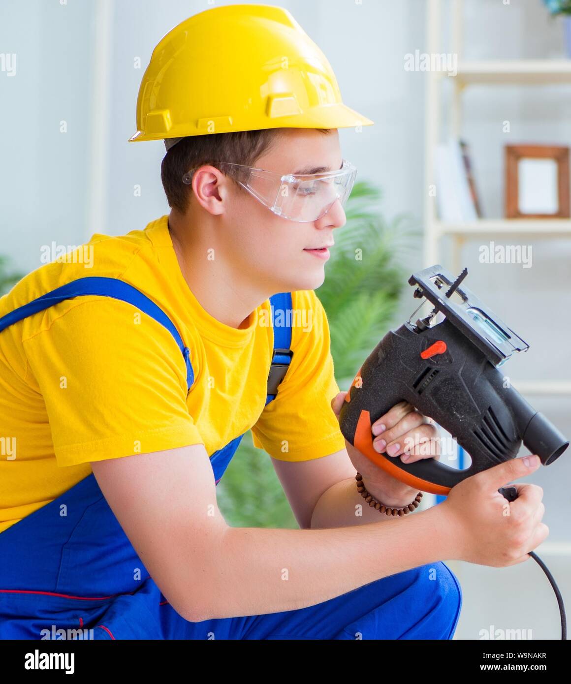 The young man assembling wood pallet Stock Photo - Alamy