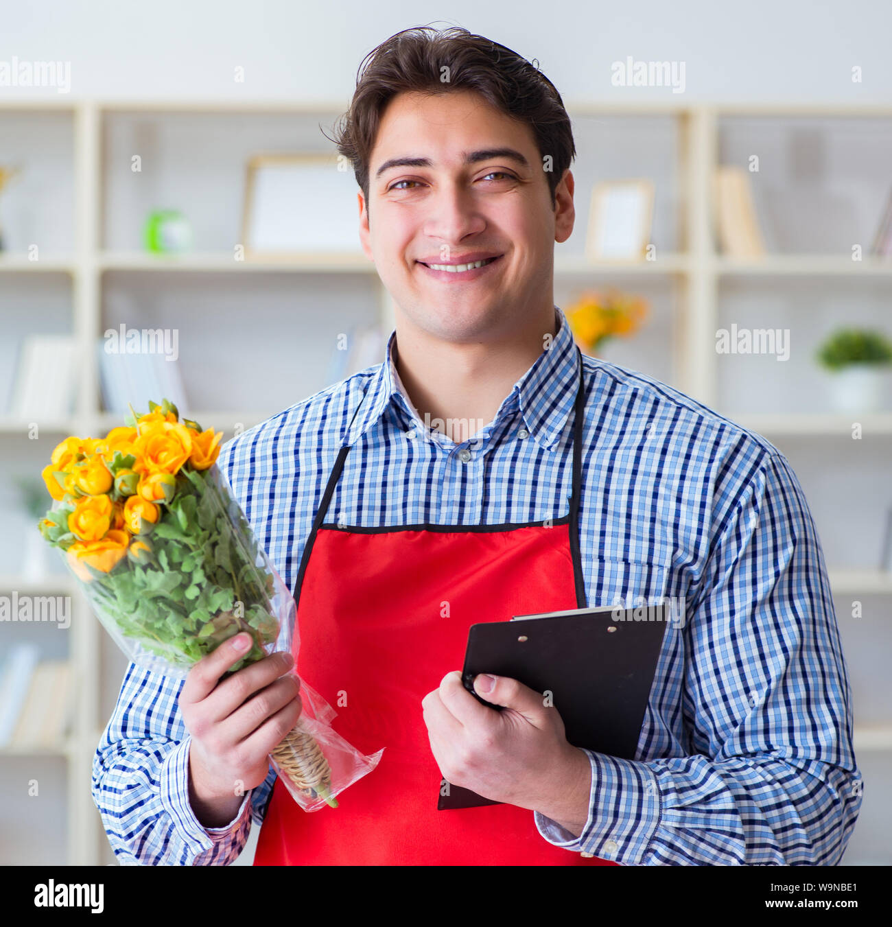 The flower shop assistant offering a bunch of flowers Stock Photo - Alamy