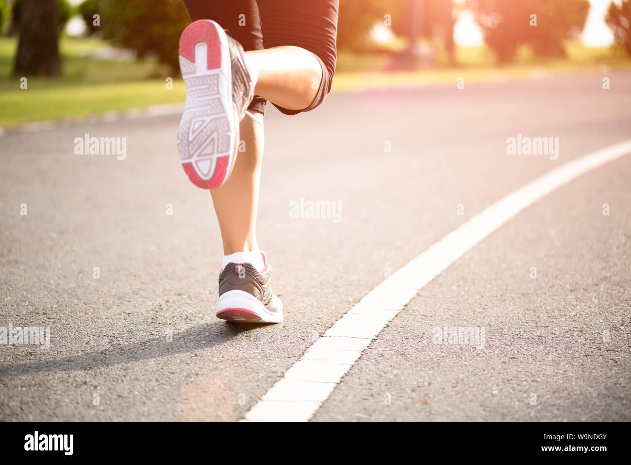 Closeup woman running towards on the road side. Step, run and outdoor ...