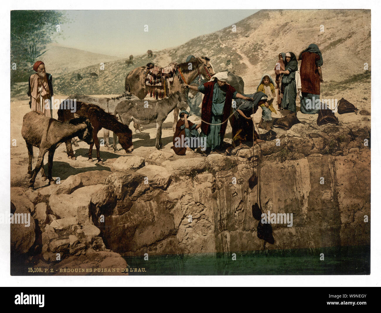 Bedouins drawing water, Holy Land Stock Photo - Alamy