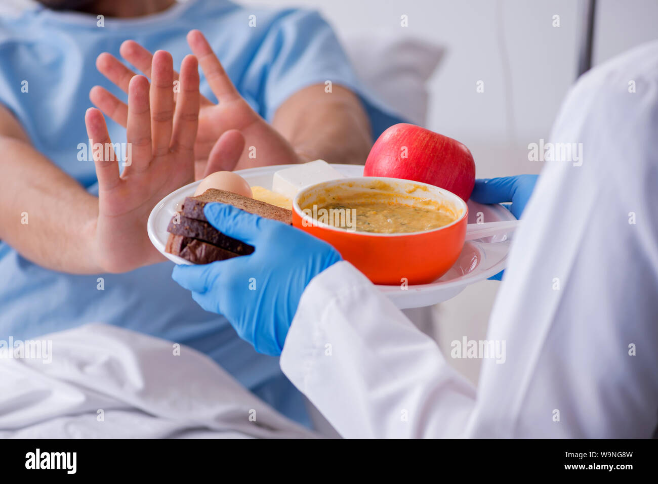 The male patient eating food in the hospital Stock Photo - Alamy
