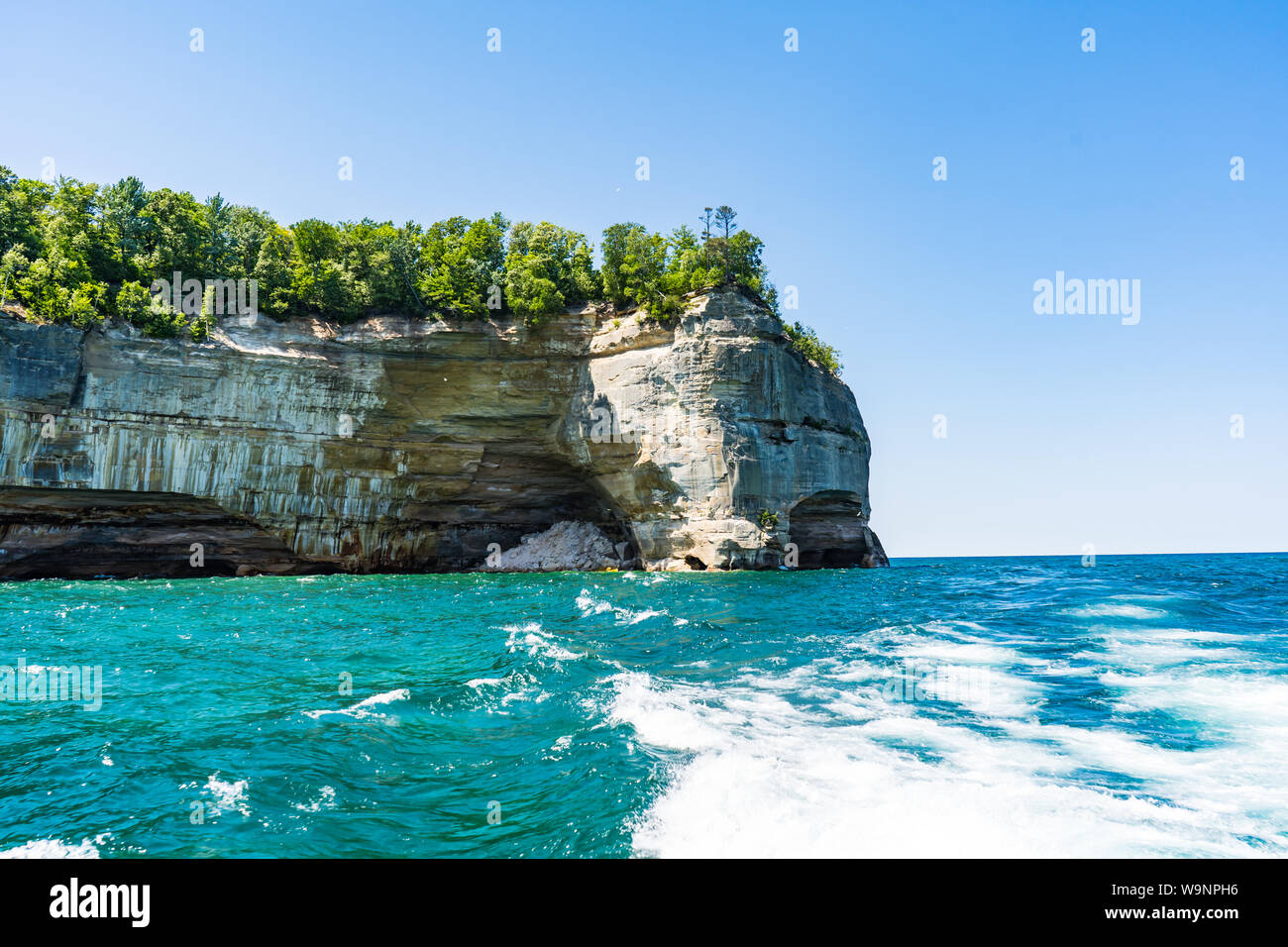 view from the lake at beautiful rocky cliff and forest , Pictured Rocks ...