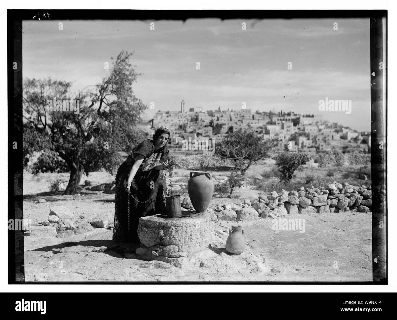 Woman drawing water from well Cut Out Stock Images & Pictures - Alamy