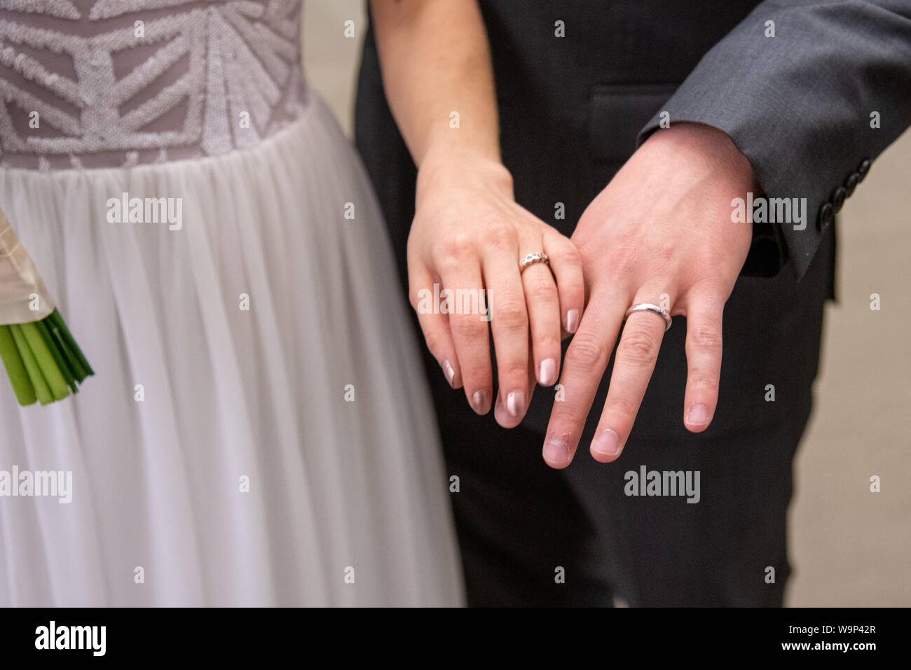 Hands of a newly married couple showing their hand with their rings ...