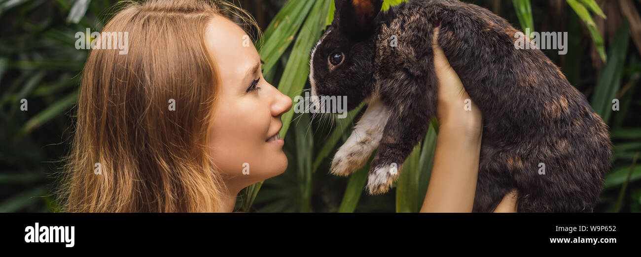 Woman holding a rabbit. Cosmetics test on rabbit animal. Cruelty free ...