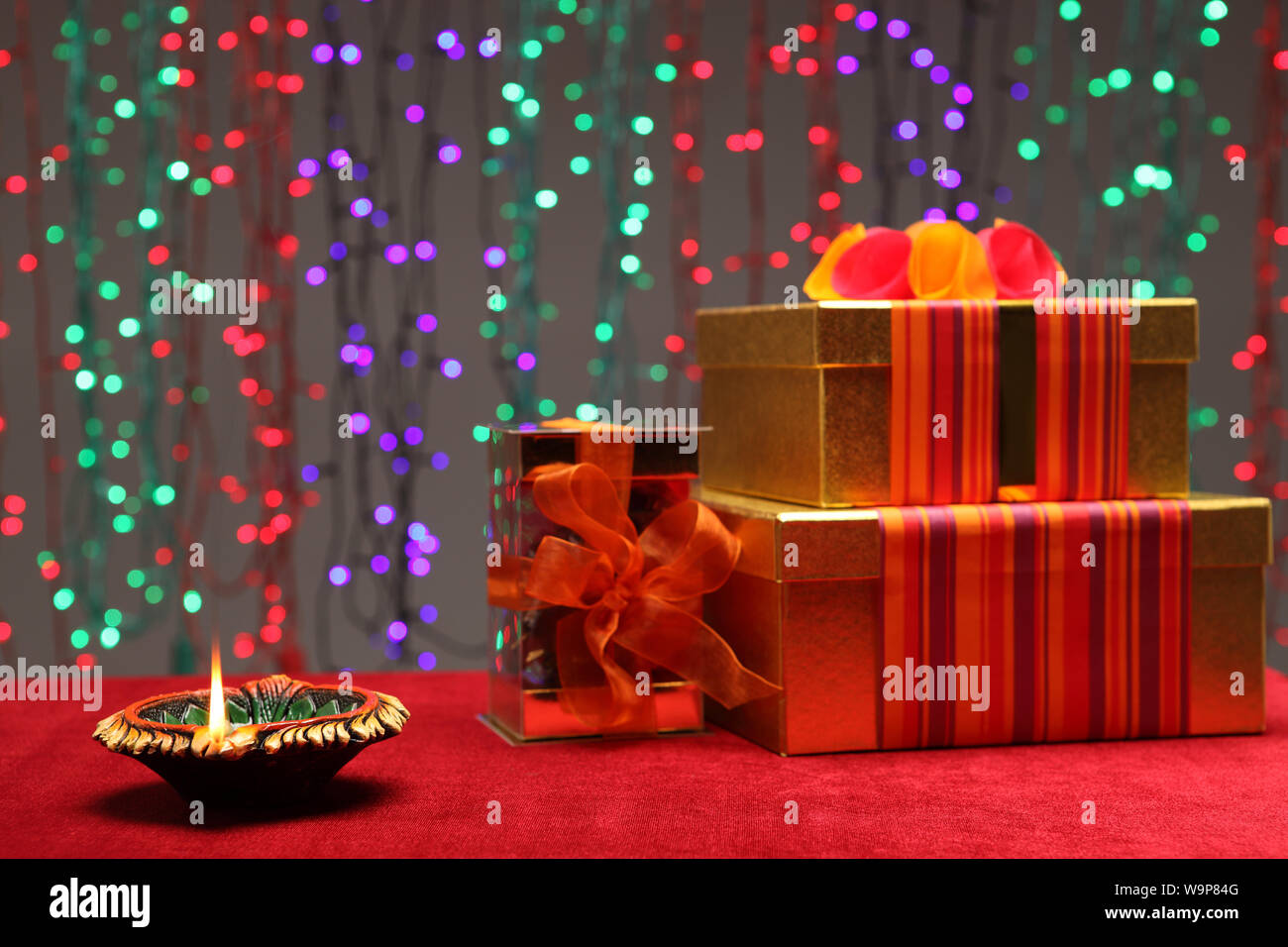 Gift boxes with a burning oil lamp Stock Photo - Alamy