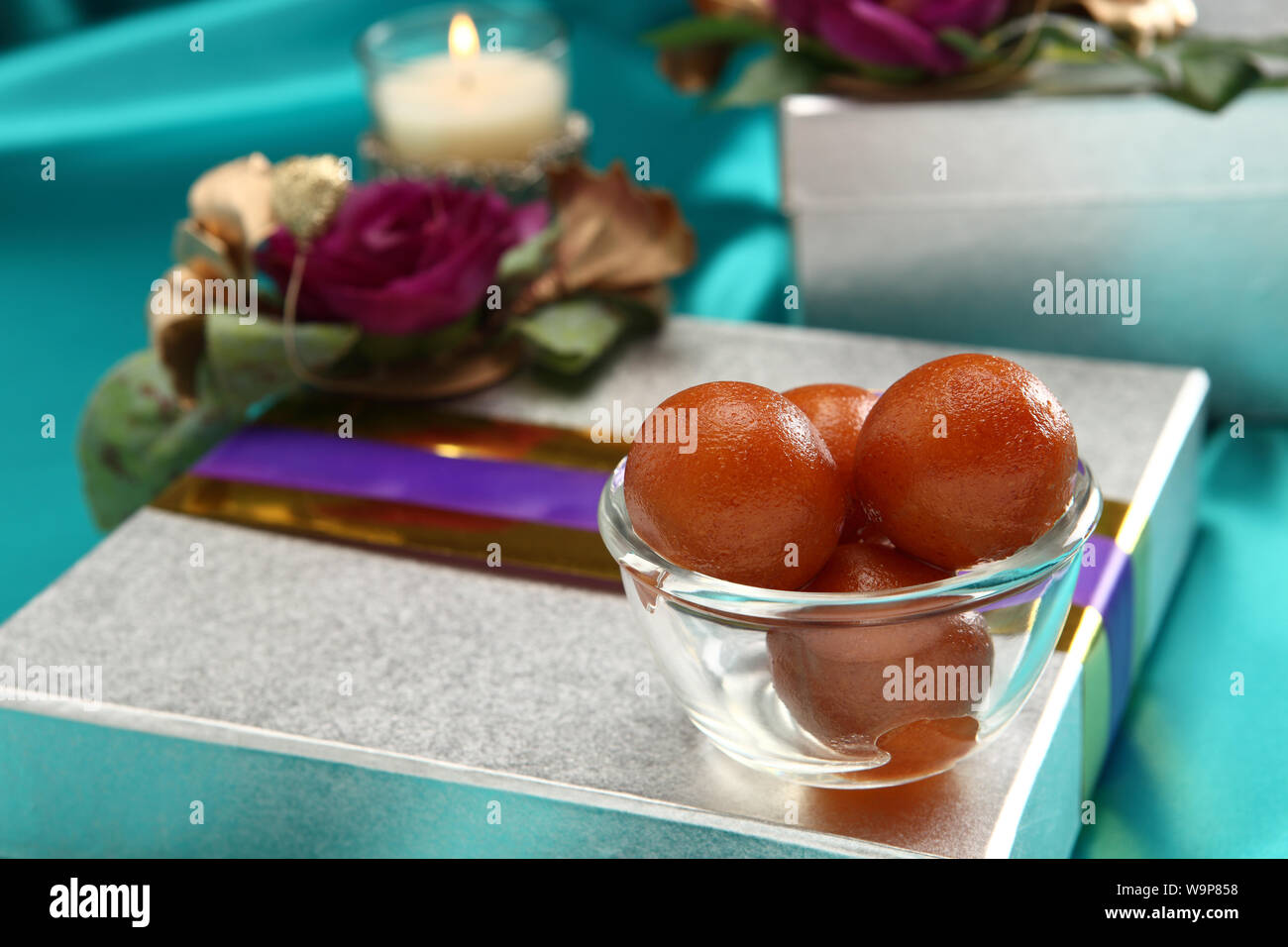 Gift boxes with a bowl of gulab jamun Stock Photo - Alamy