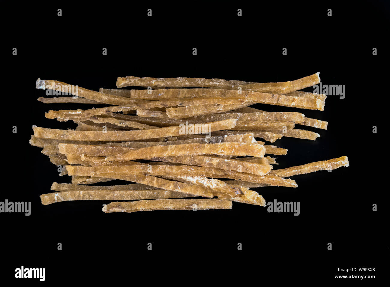 dried fish fillet cut into strips on a dark background close-up Stock ...